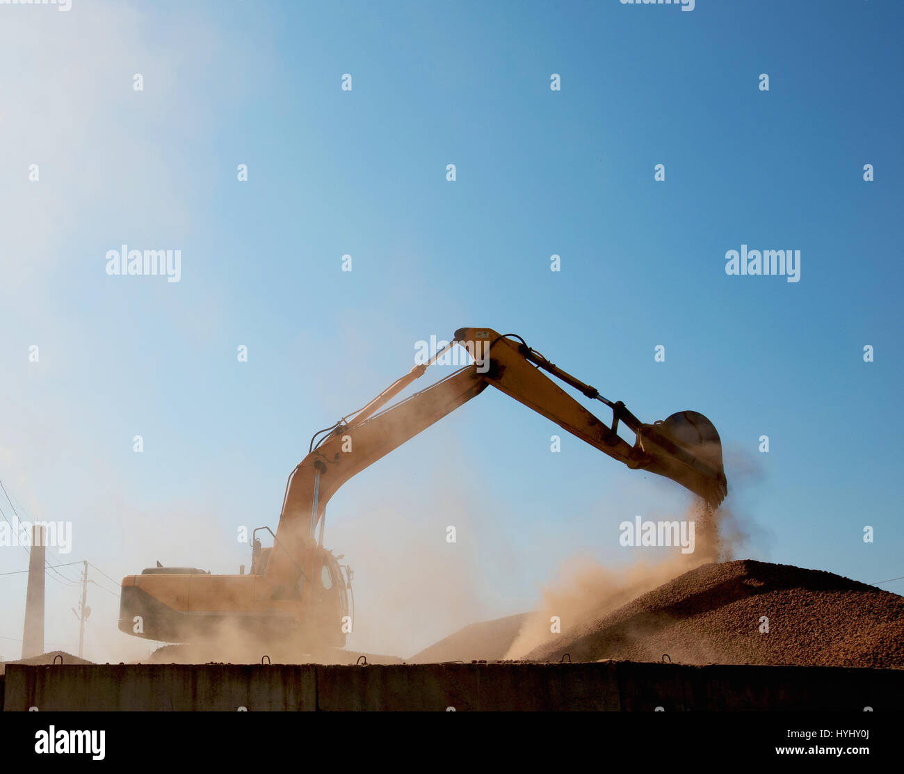 big excavator delivers expanded clay Stock Photo - Alamy