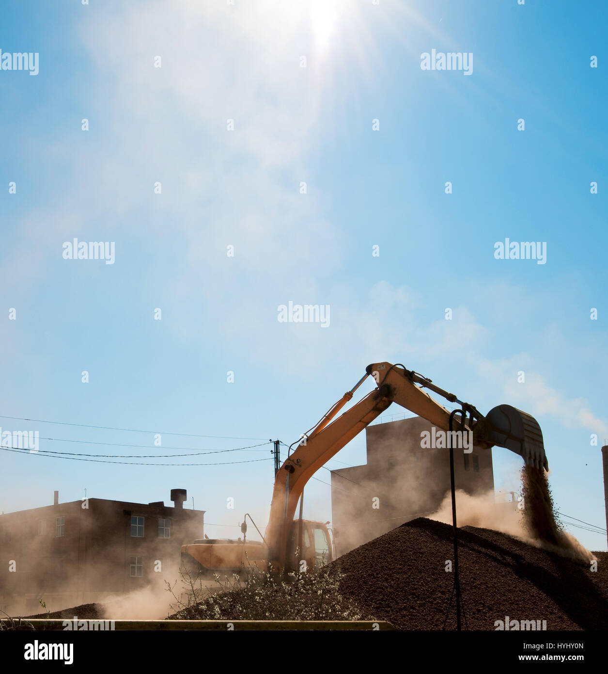 big heavy excavator delivers expanded clay Stock Photo - Alamy