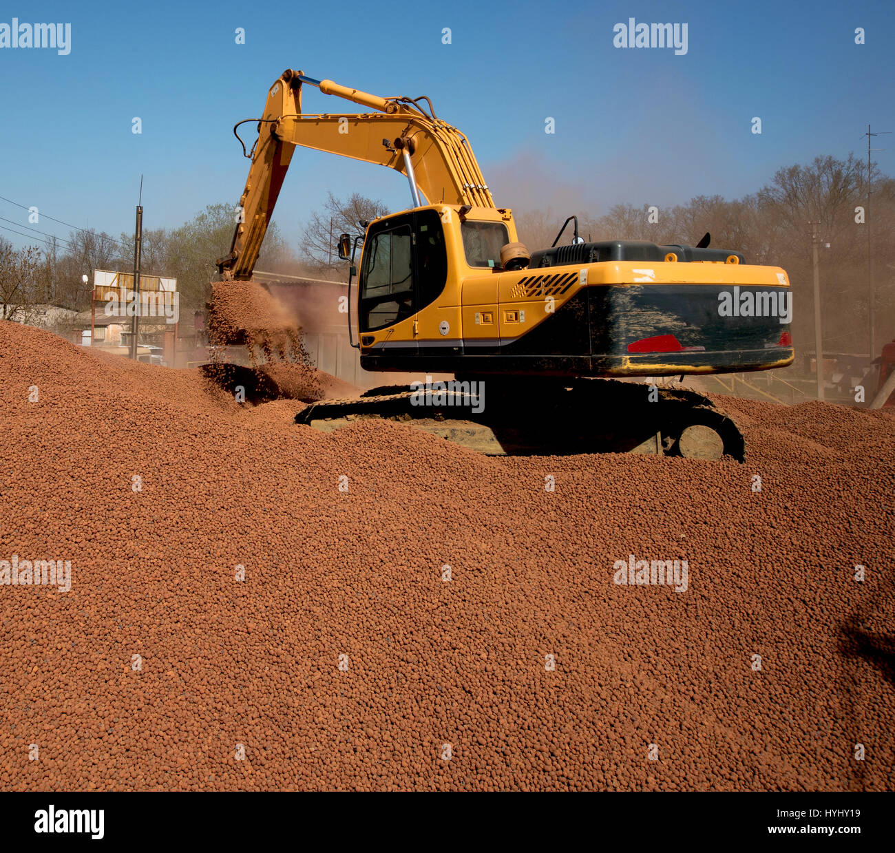 excavator loads materials at the plant Stock Photo - Alamy