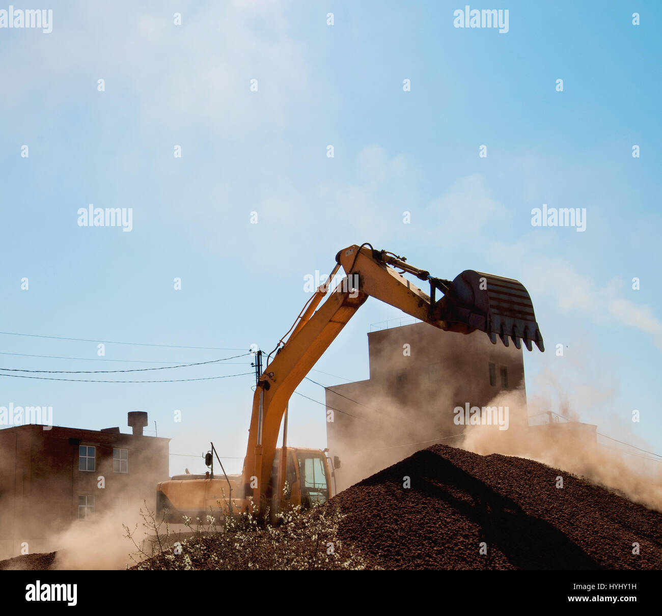 heavy excavator delivers expanded clay Stock Photo - Alamy