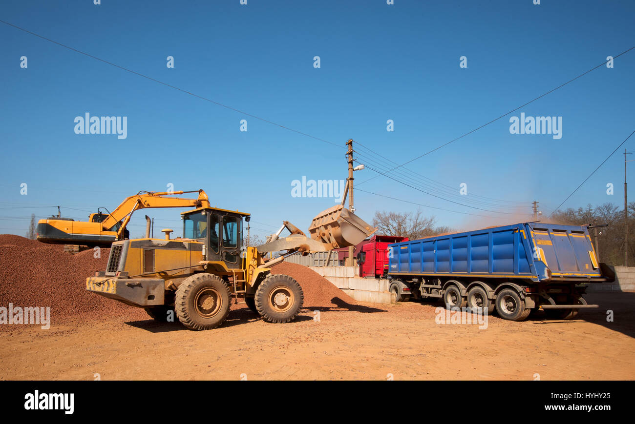 process of loading of clay into the dump truck Stock Photo - Alamy