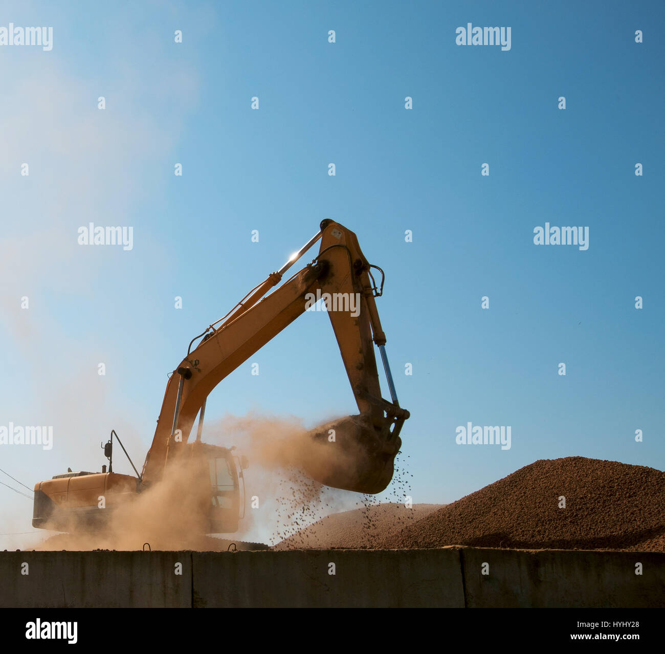 tracked heavy excavator delivers expanded clay Stock Photo - Alamy