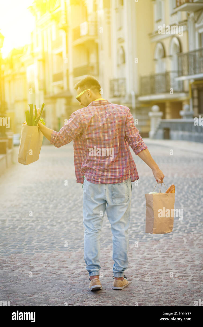 Young man with products Stock Photo - Alamy
