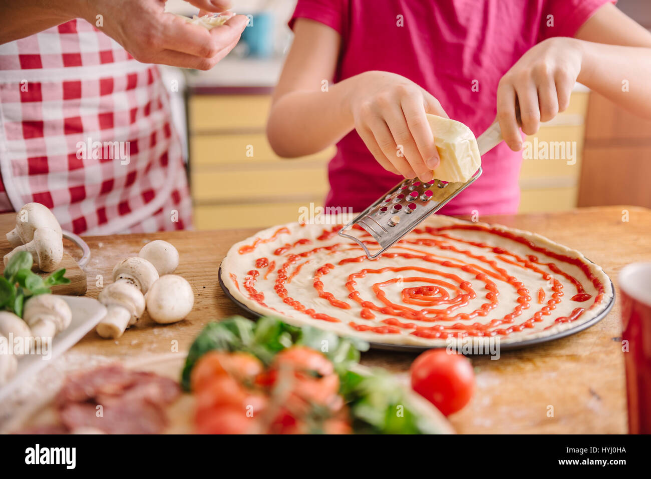 Mother and daughter preparing pizza in the kitchen Stock Photo - Alamy