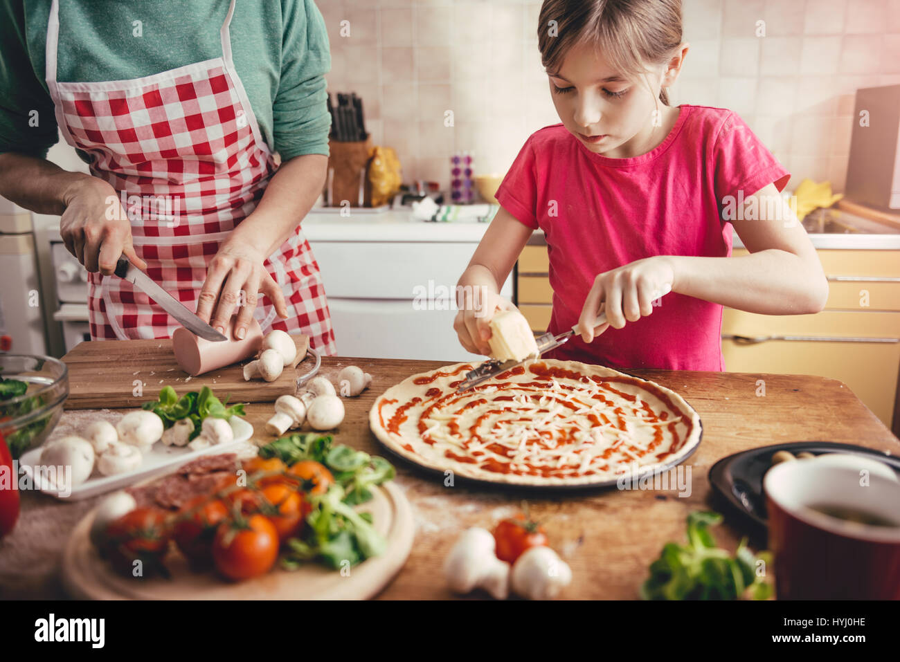 Mother and daughter preparing pizza in the kitchen Stock Photo - Alamy