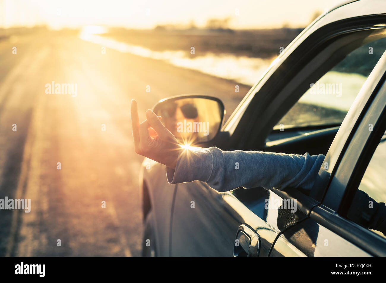 Woman driver shows midle finger on the road Stock Photo - Alamy