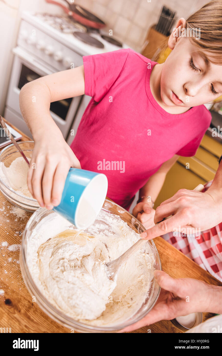 Daughter and mother making pizza dough in the kitchen Stock Photo - Alamy