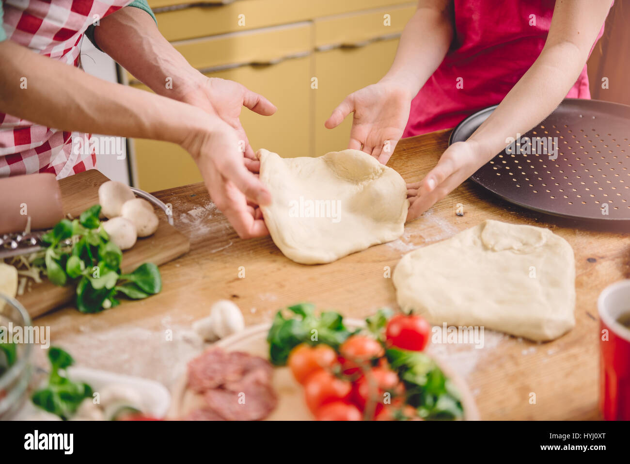 Mother and daughter preparing pizza in the kitchen Stock Photo - Alamy