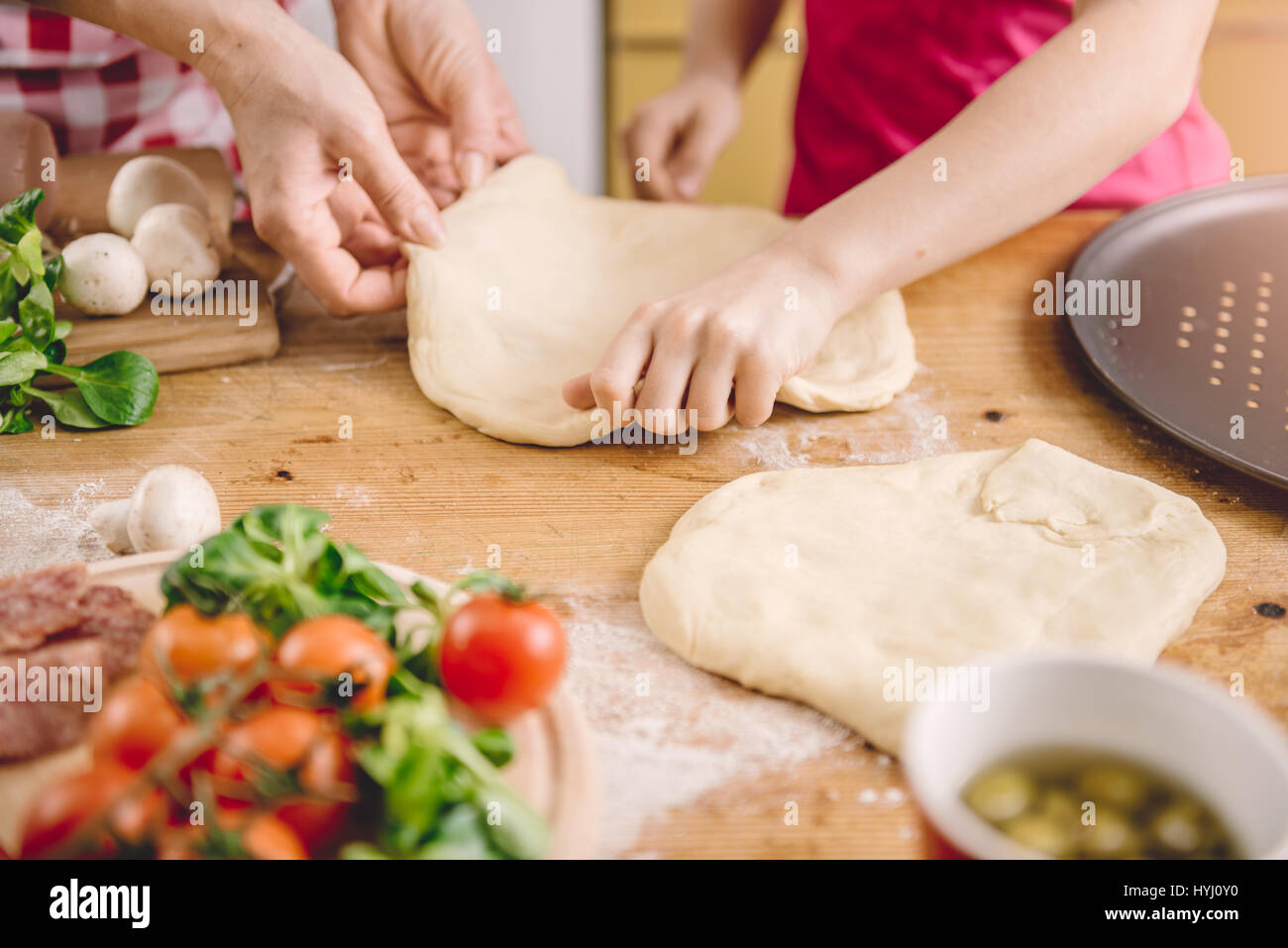 Mother and daughter preparing pizza in the kitchen Stock Photo - Alamy