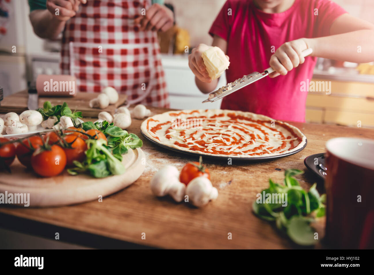 Mother and daughter preparing pizza in the kitchen Stock Photo - Alamy