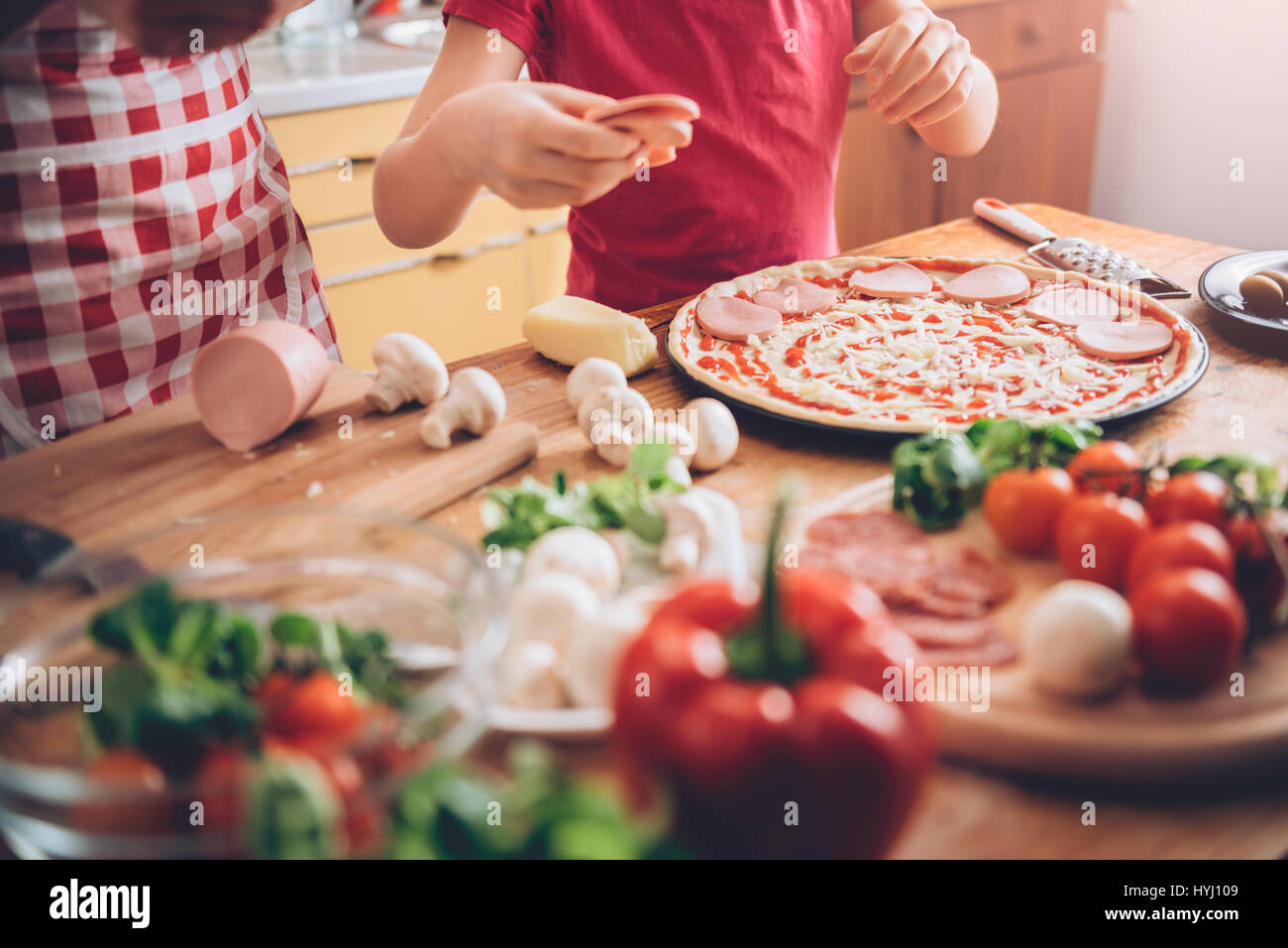 Mother and daughter preparing pizza in the kitchen Stock Photo - Alamy