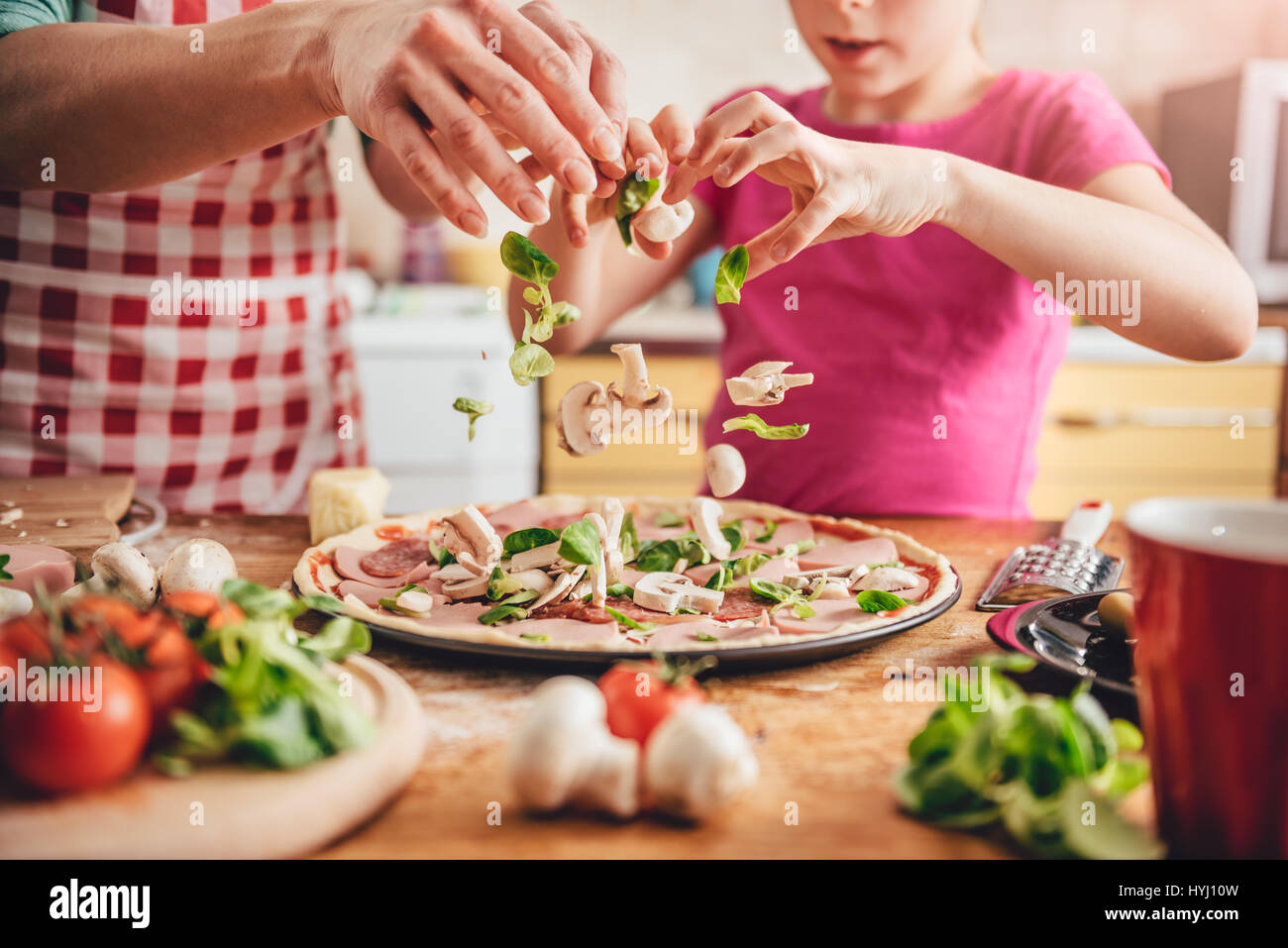 Mother and daughter preparing pizza in the kitchen Stock Photo - Alamy