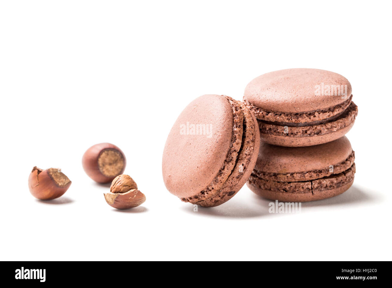 Closeup of tasty macaroons with nut on white background Stock Photo - Alamy