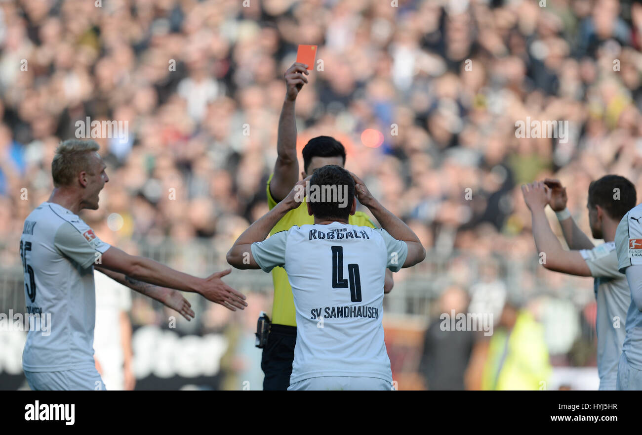 Hamburg, Germany. 04th Apr, 2017. Sandhausen's Damian Roßbach (C) gets ...