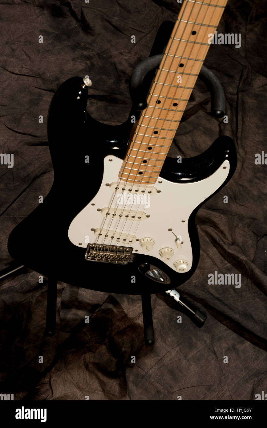 six string strat electric guitar on stand Stock Photo - Alamy