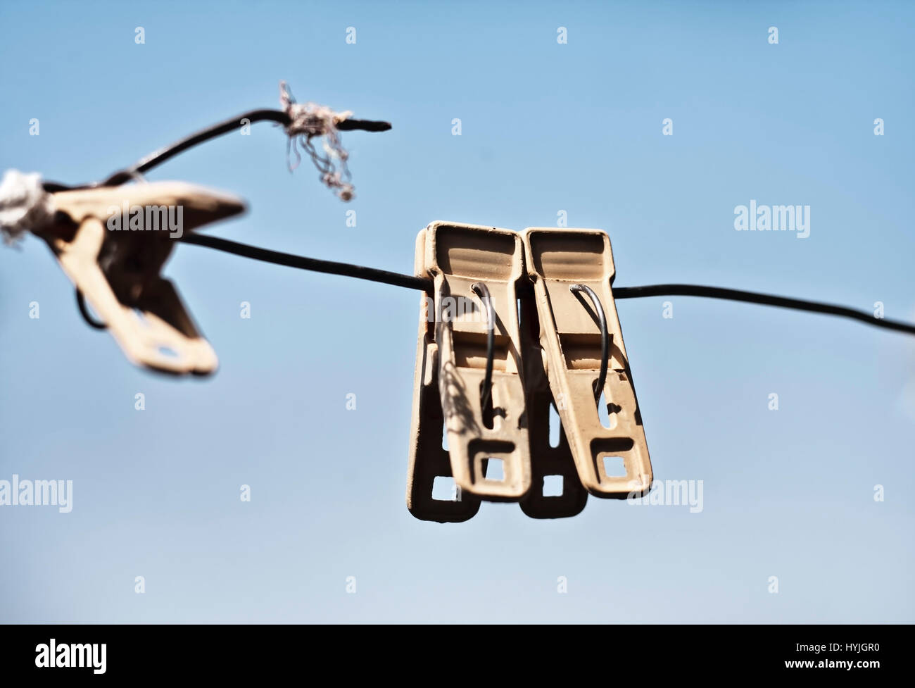 two washing clips on the wire Stock Photo - Alamy