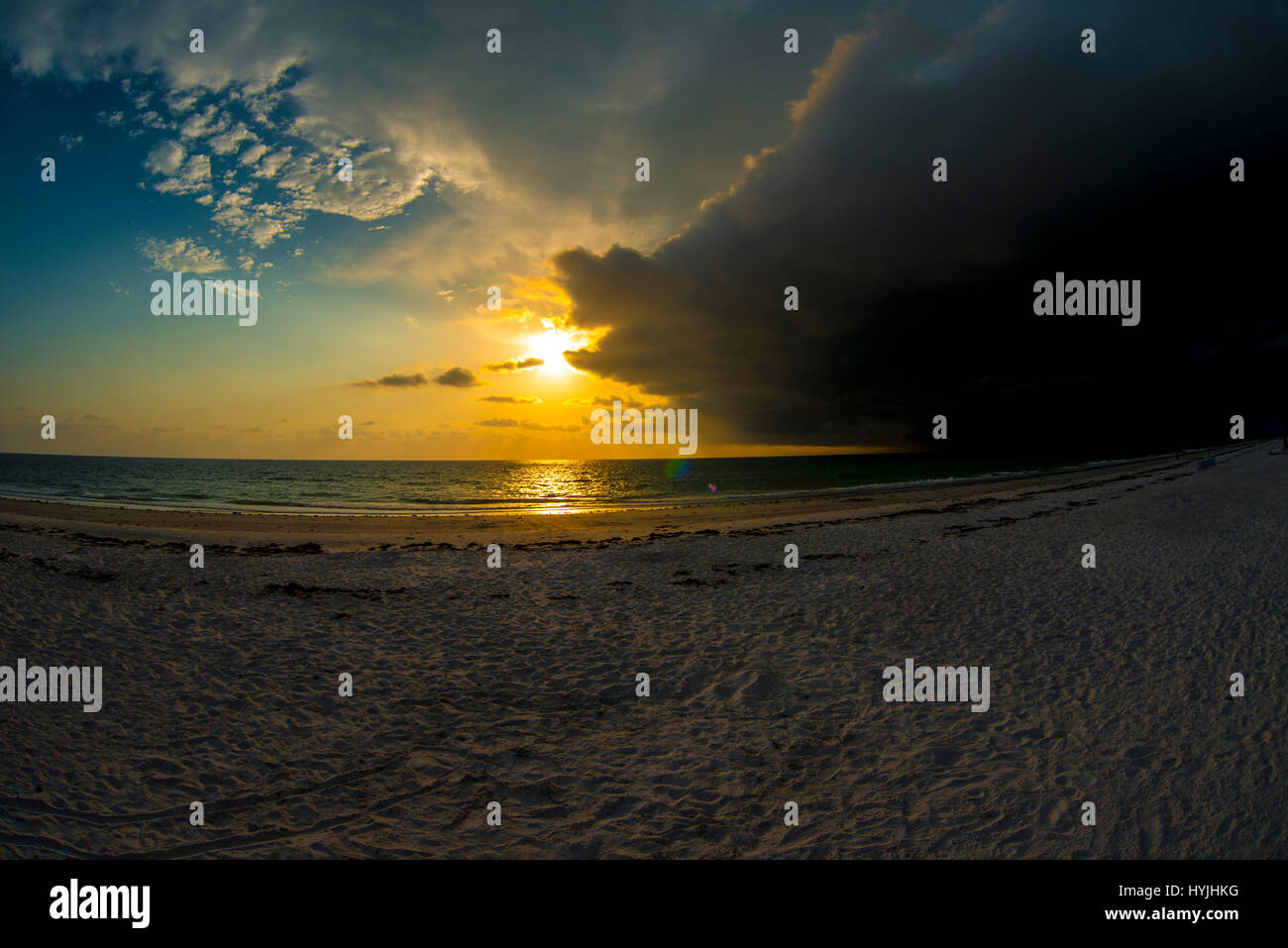 sunrise at the beach with storm coming Stock Photo - Alamy