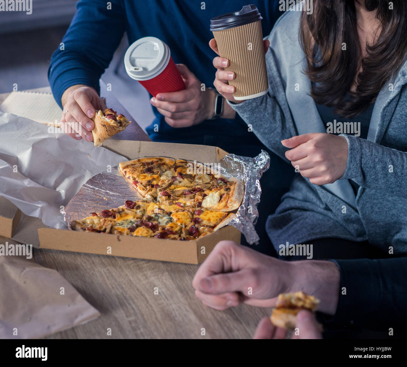Eating pizza in the office together. Food delivery. Concept of ...