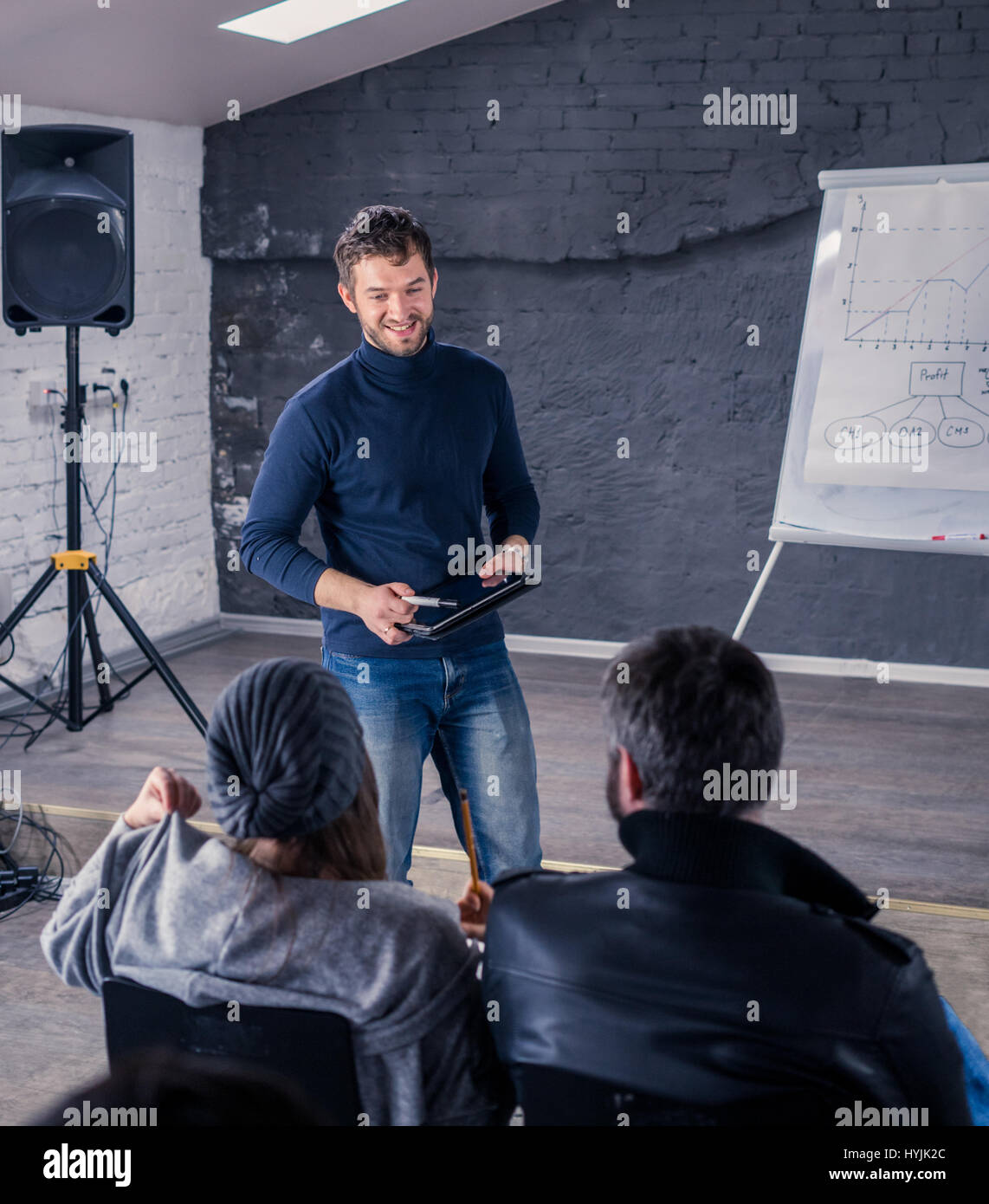 Young speaker man talking to audience during conference. Business ...