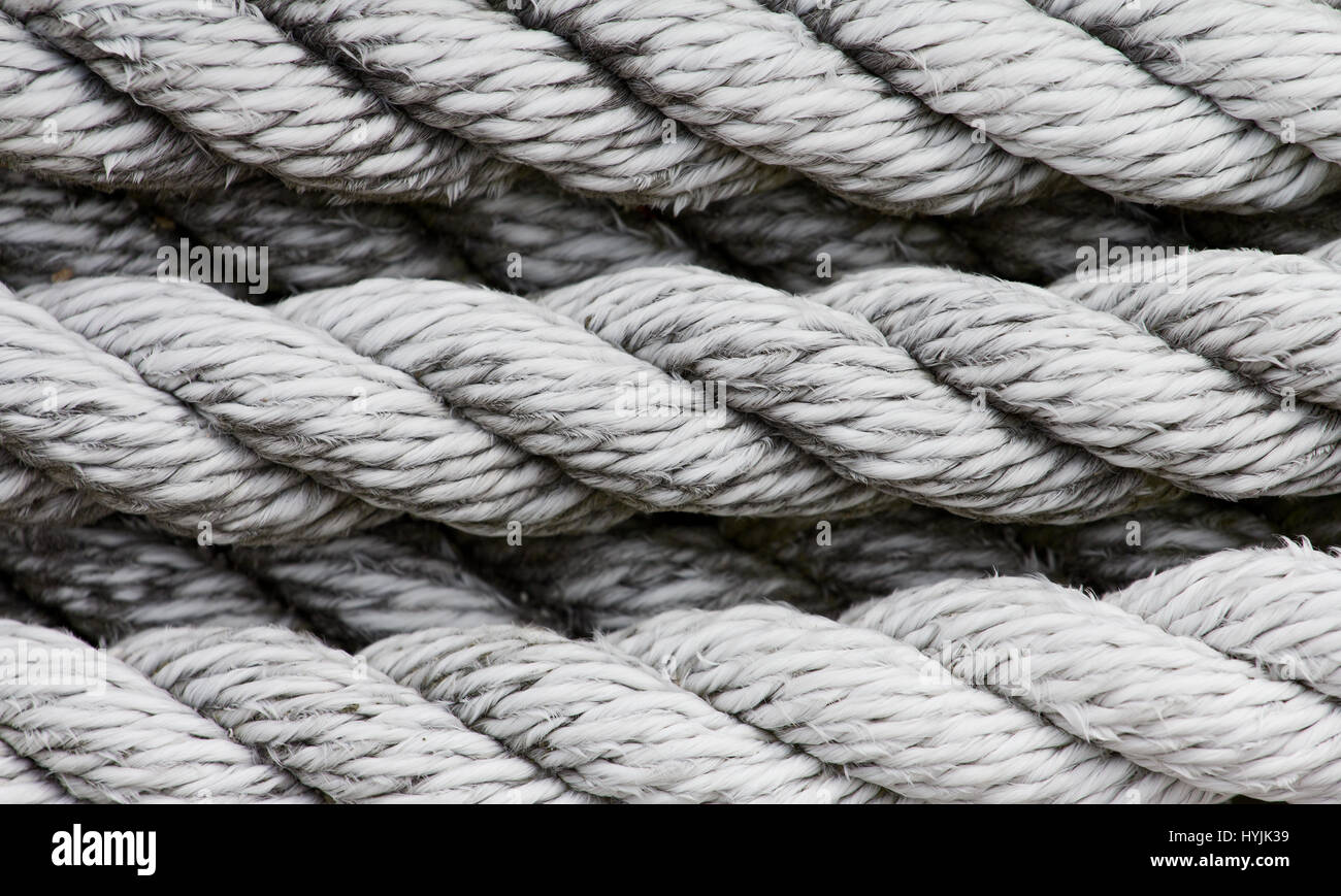 Think rope tied around dock piling Stock Photo - Alamy