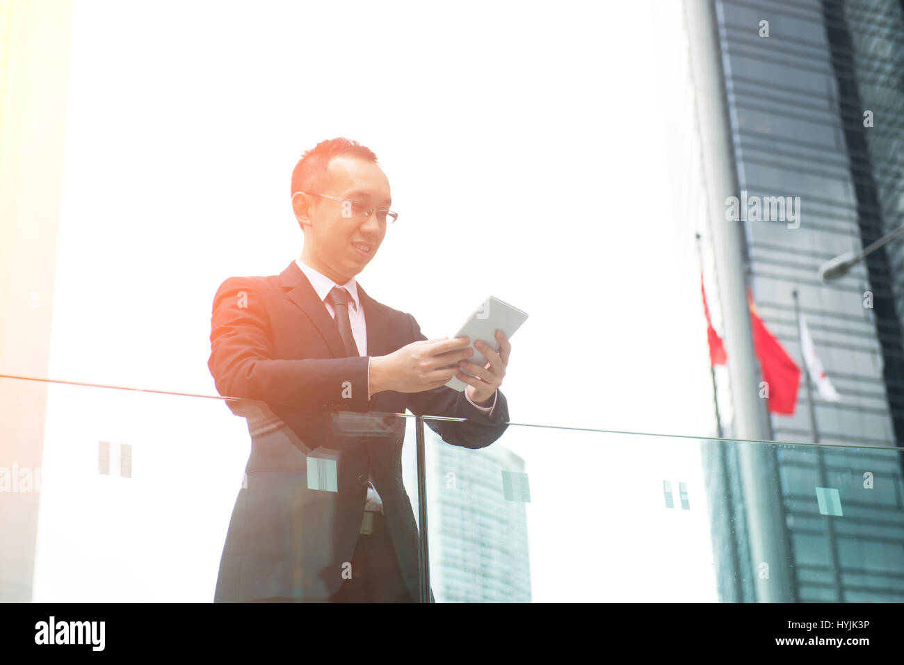 asian man using tablet outdoor Stock Photo - Alamy