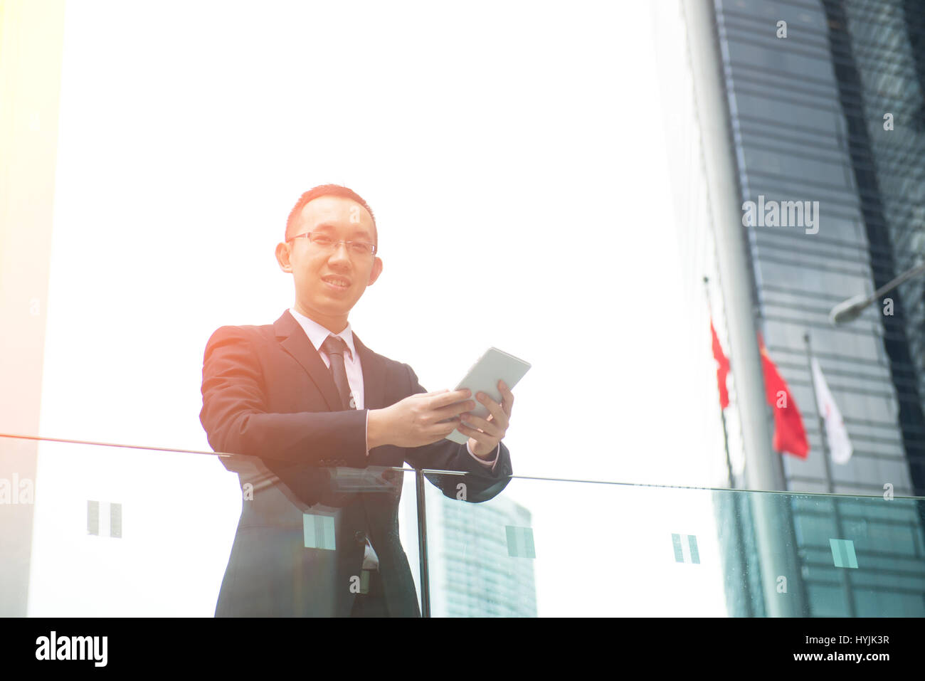 asian man using tablet outdoor Stock Photo - Alamy