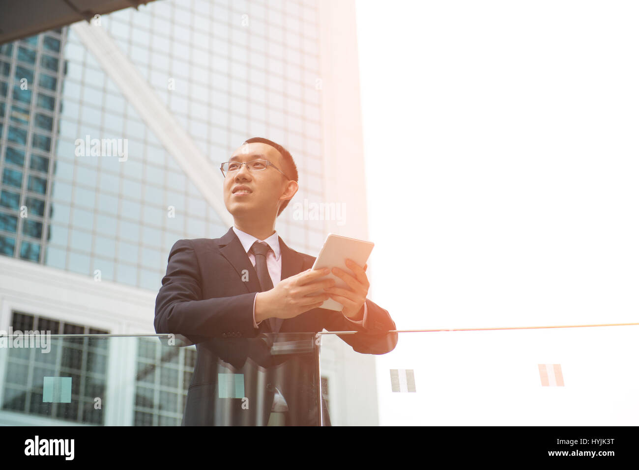 asian man using tablet outdoor Stock Photo - Alamy