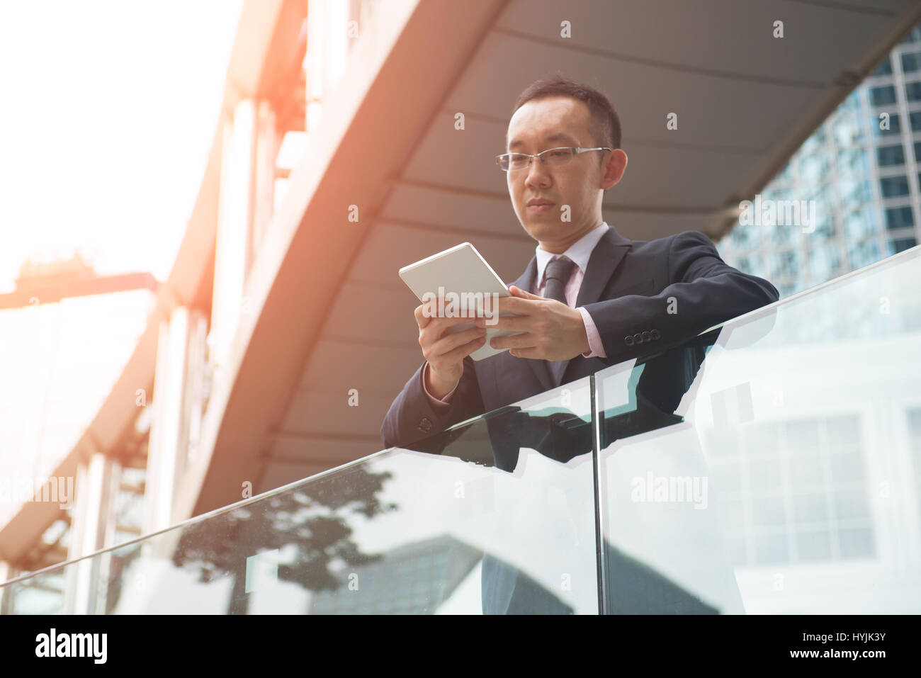asian man using tablet outdoor Stock Photo - Alamy
