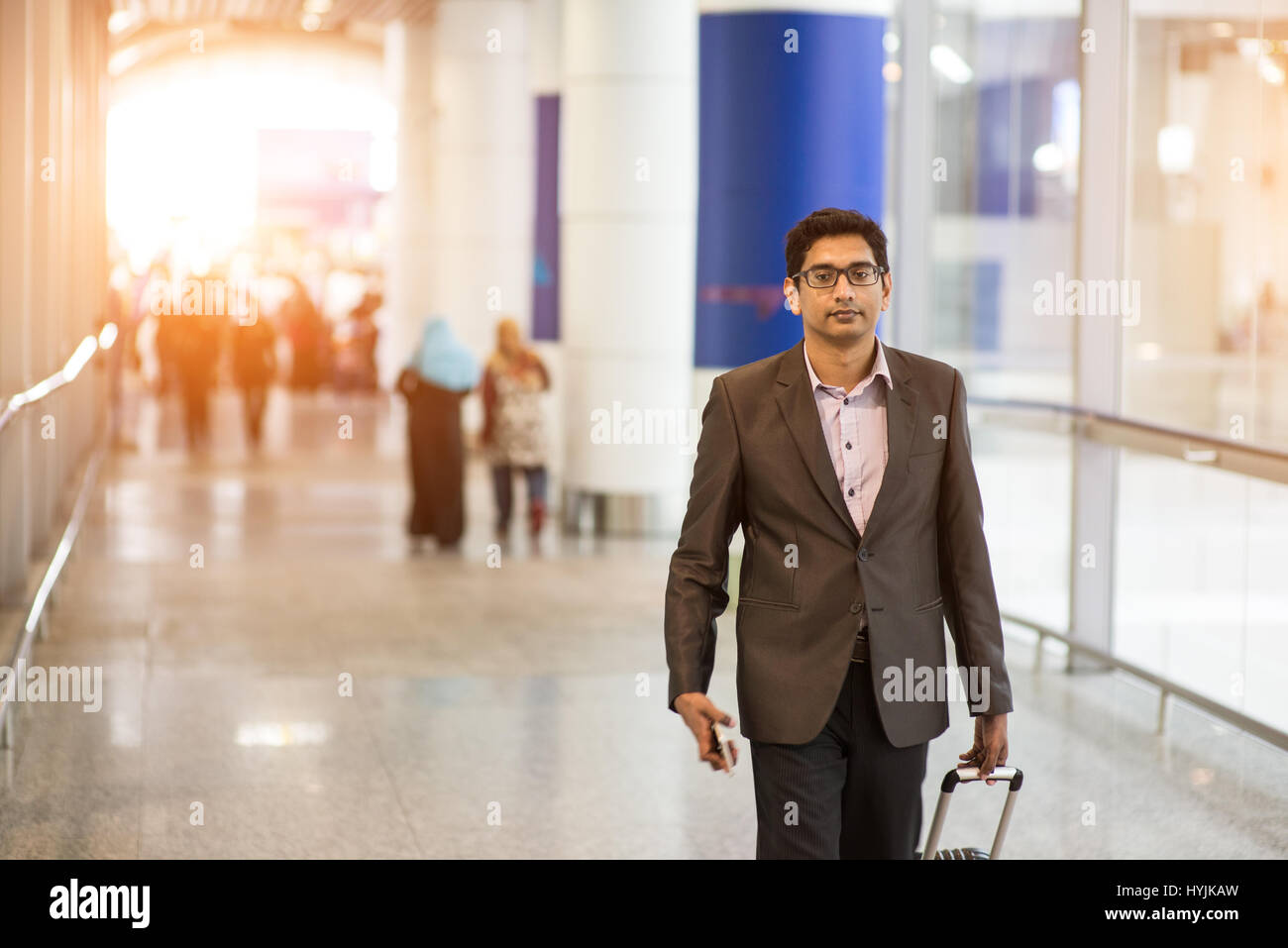 indian male walking at airport Stock Photo - Alamy
