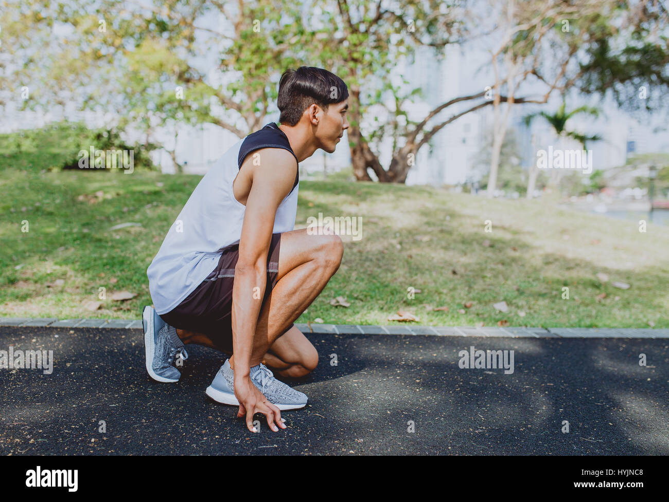 Man preparing to run in park Stock Photo - Alamy