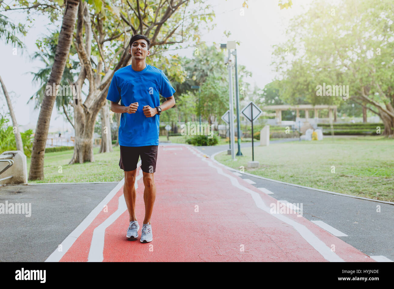 Running man. Male runner jogging during outdoor workout at public park ...