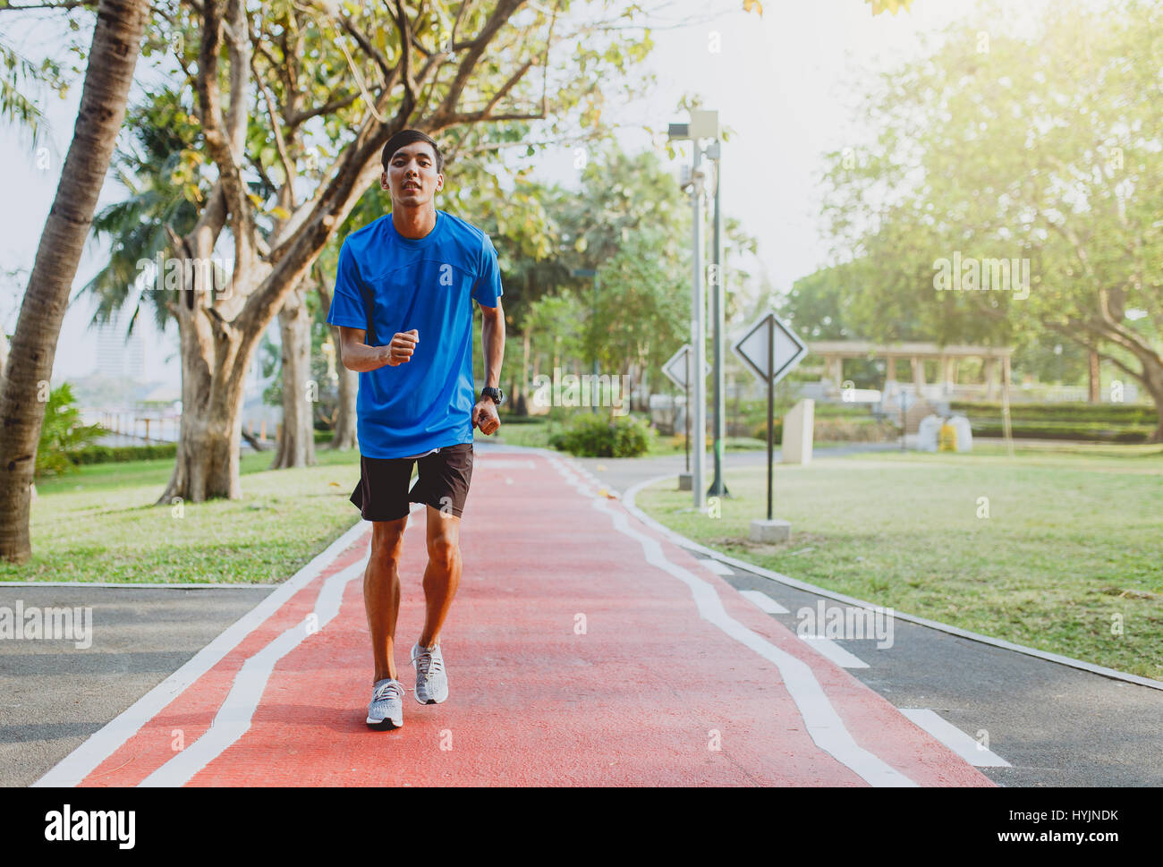 Running man. Male runner jogging during outdoor workout at public park ...