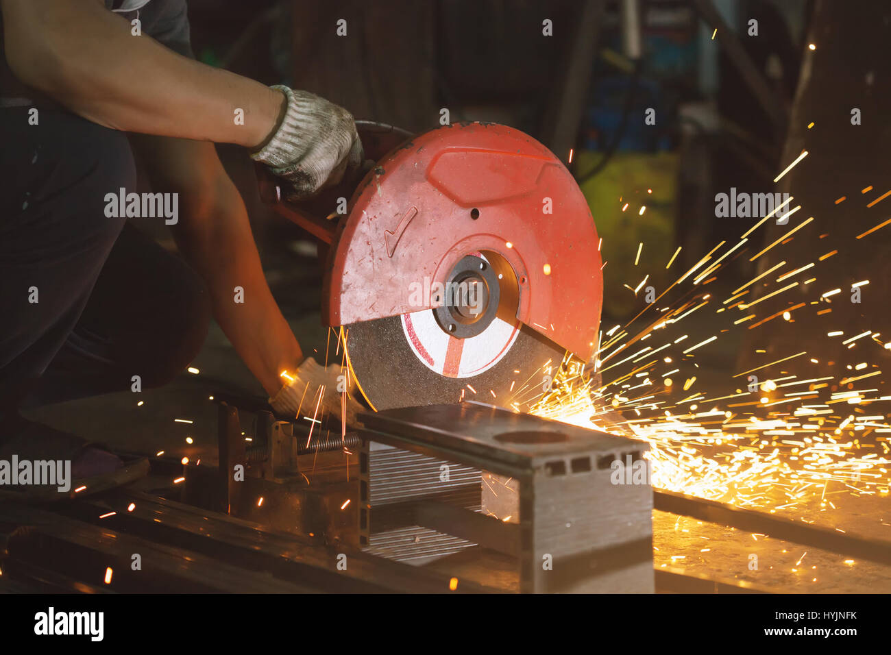 Men use Electric grinder on a workshop Stock Photo - Alamy