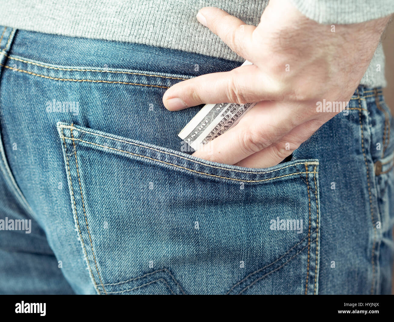 his hand put dollars in jeans pocket or take out from pocket Stock ...