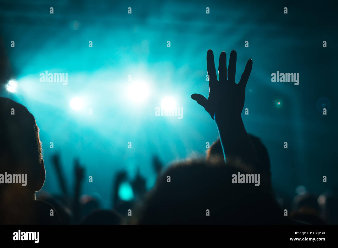Female hand raised in the air on rock music concert, enjoying popular ...