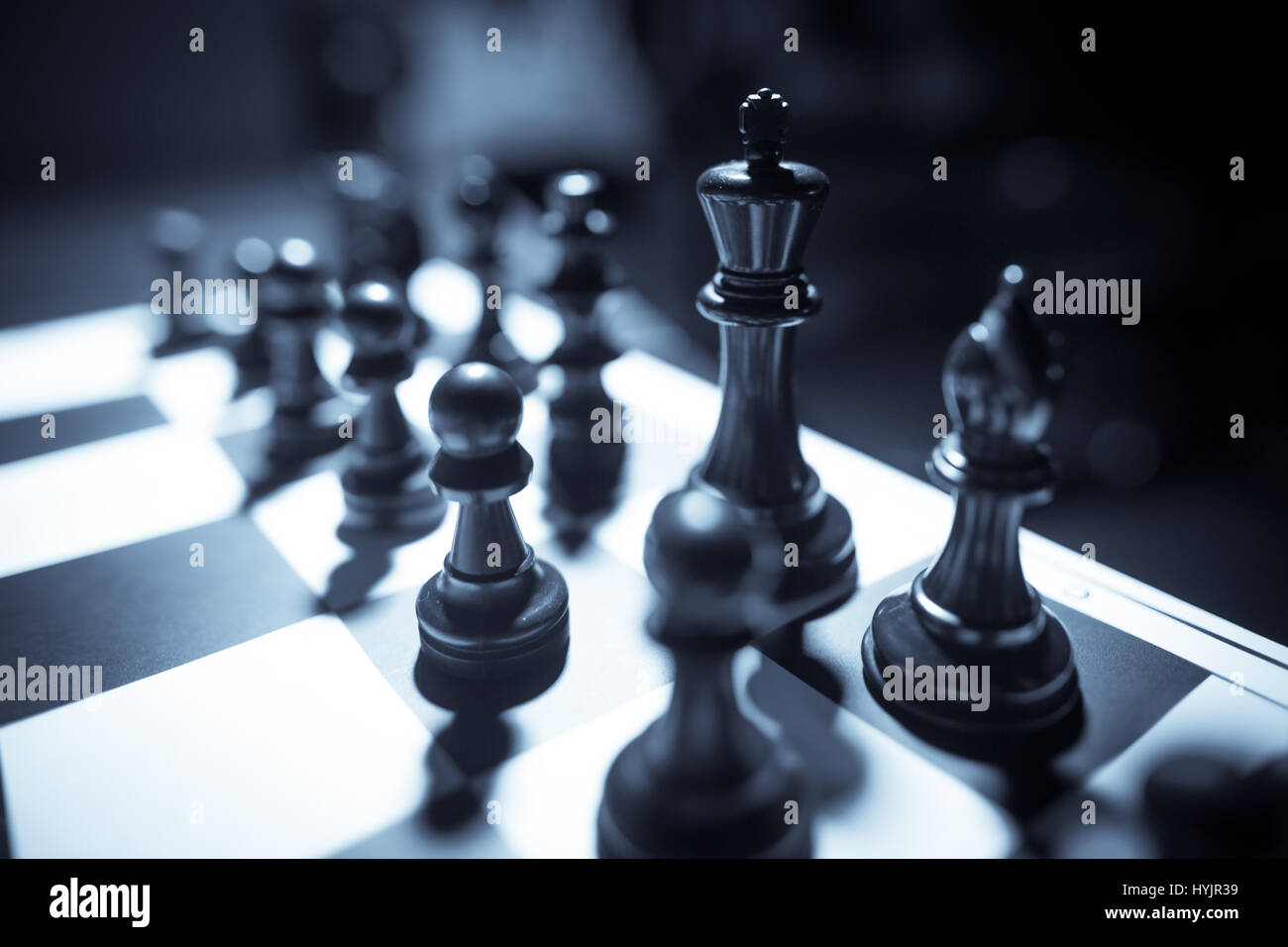 Image of the black pieces on a chess board, with shallow depth of field ...