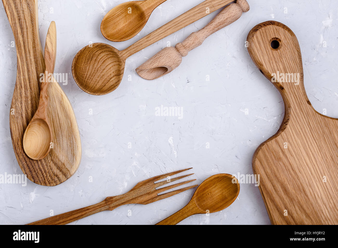 Frame of kitchen wooden utensils. Oak wood cutting board,spoons and ...