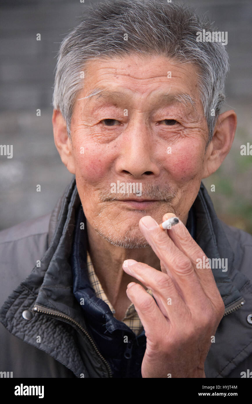 Asia,China,Beijing,senior man smoking Stock Photo - Alamy