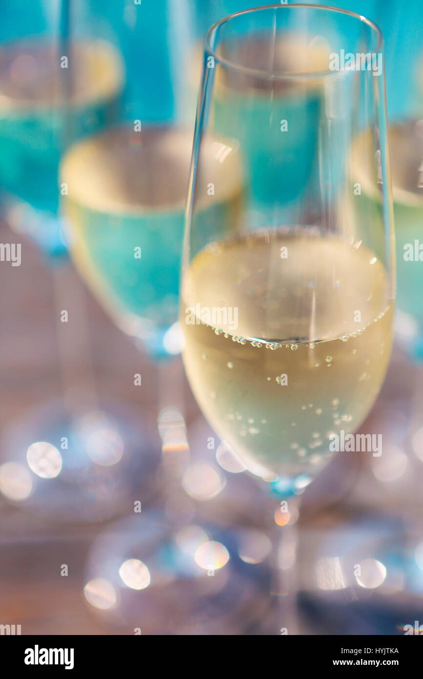 Champagne glasses on wooden background near pool. Summer pool party ...
