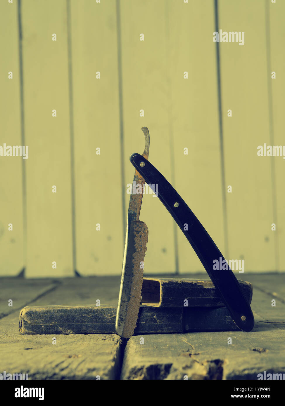 Old and rusty razor on a rustic workbench with space for text or image ...