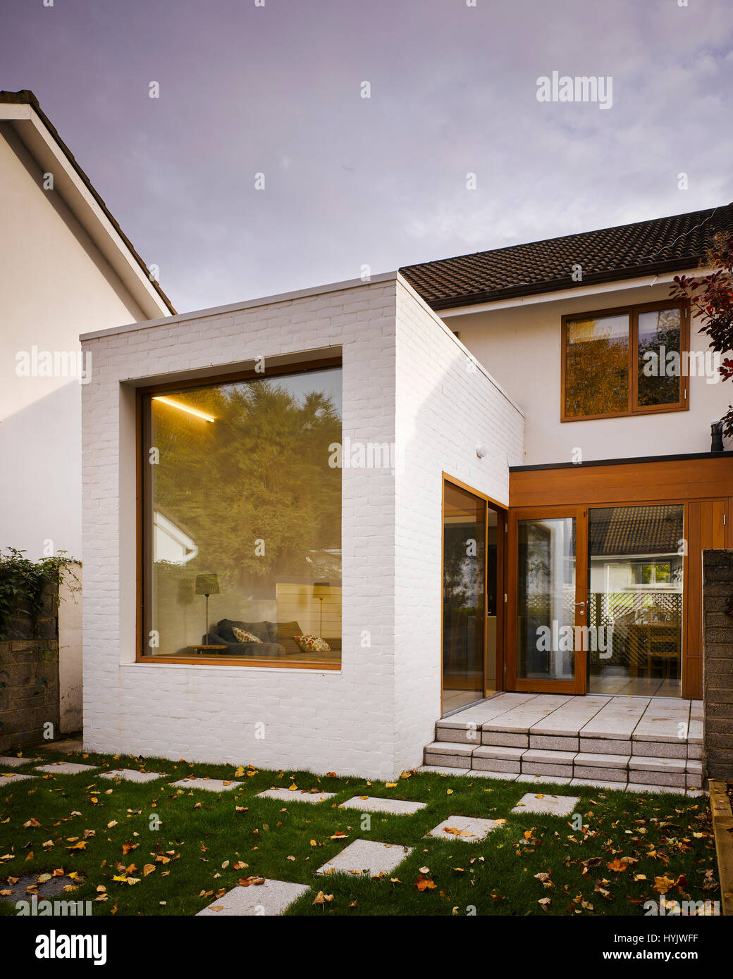 Exterior view of extension showing window and glass doors. Extension to ...