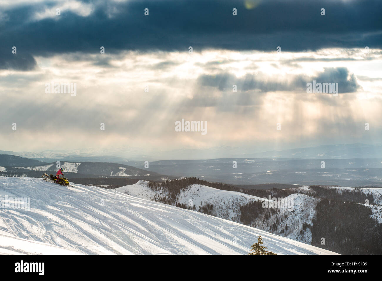 Rider on the snowmobile in the mountains Stock Photo - Alamy