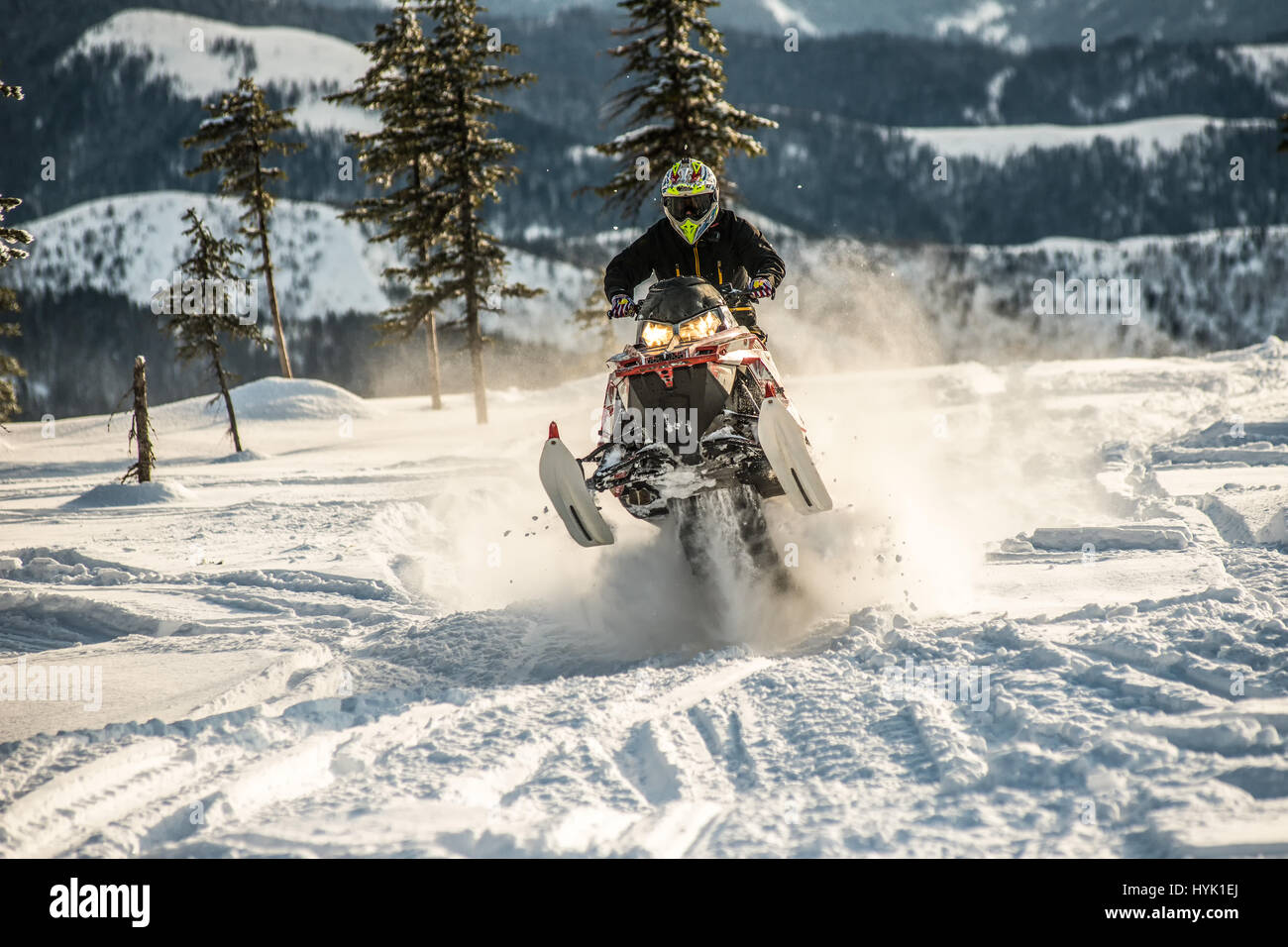 Rider on the snowmobile in the mountains. active drive Stock Photo - Alamy