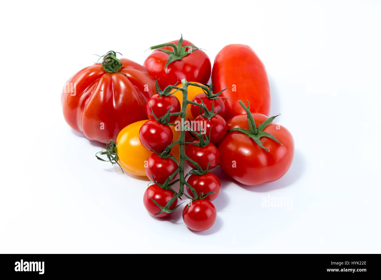 Many different varieties of fresh tomatoes isolated in white background ...