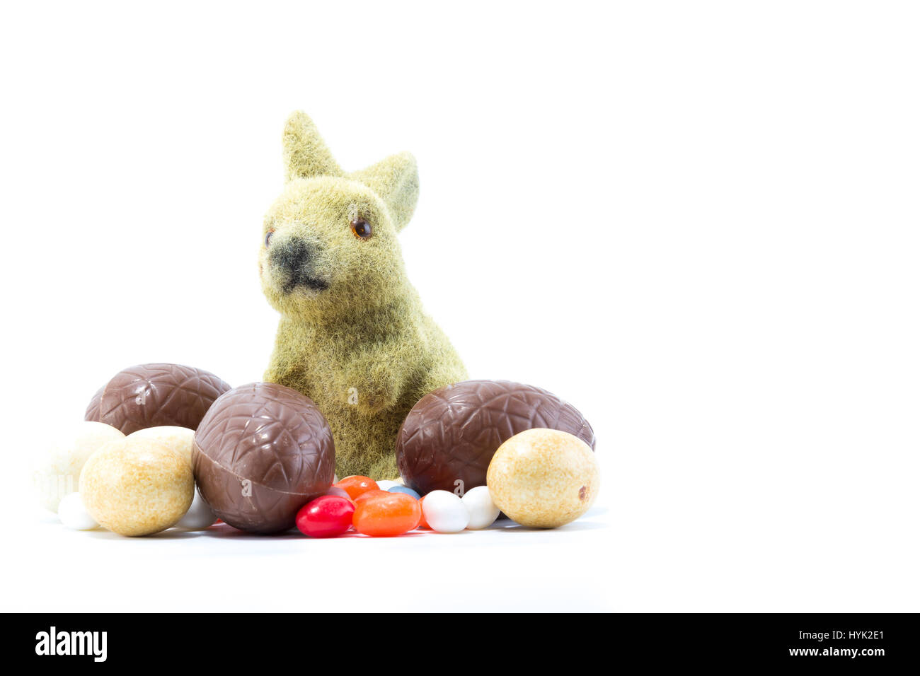 Easter bunny with different kinds and colors of chocolate easter eggs ...