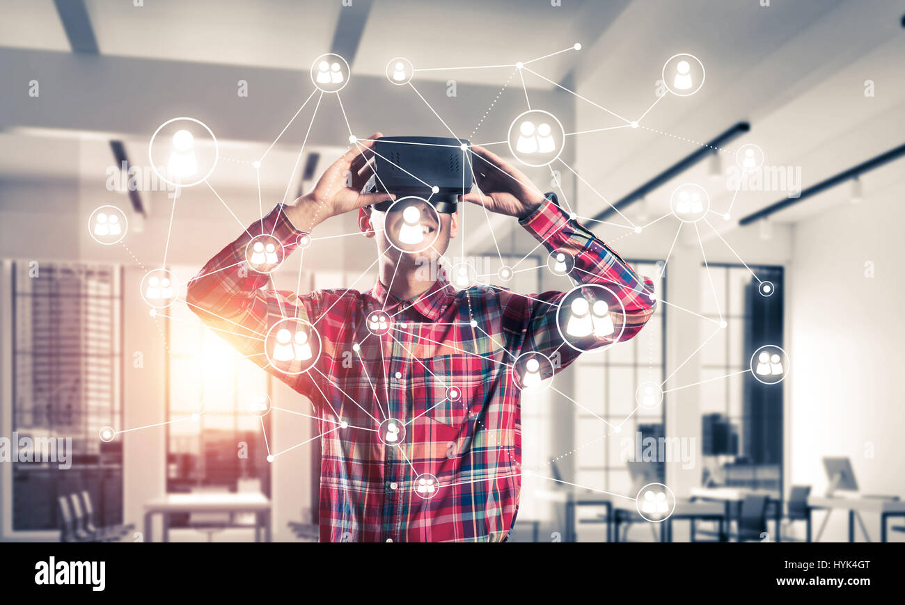 Guy wearing checked shirt and virtual mask demonstrating some em Stock ...