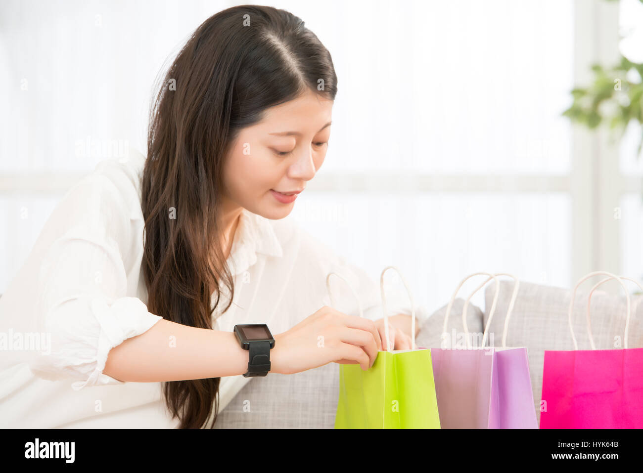 charming asian woman enjoy online shopping with smartwatch sitting on ...
