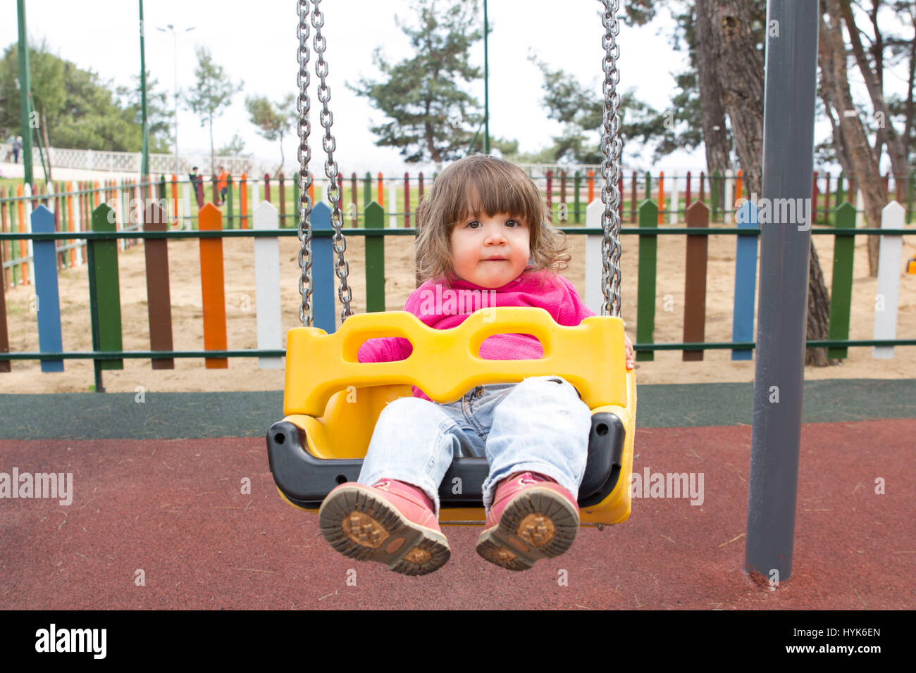 child on swing in playground Stock Photo - Alamy