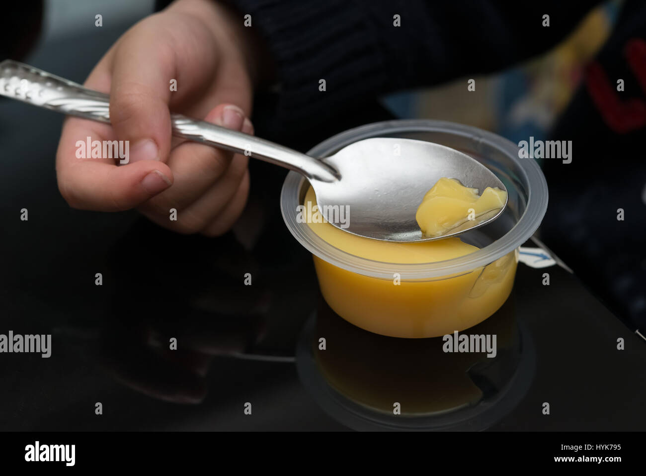 kid eating mango flavor pudding Stock Photo - Alamy