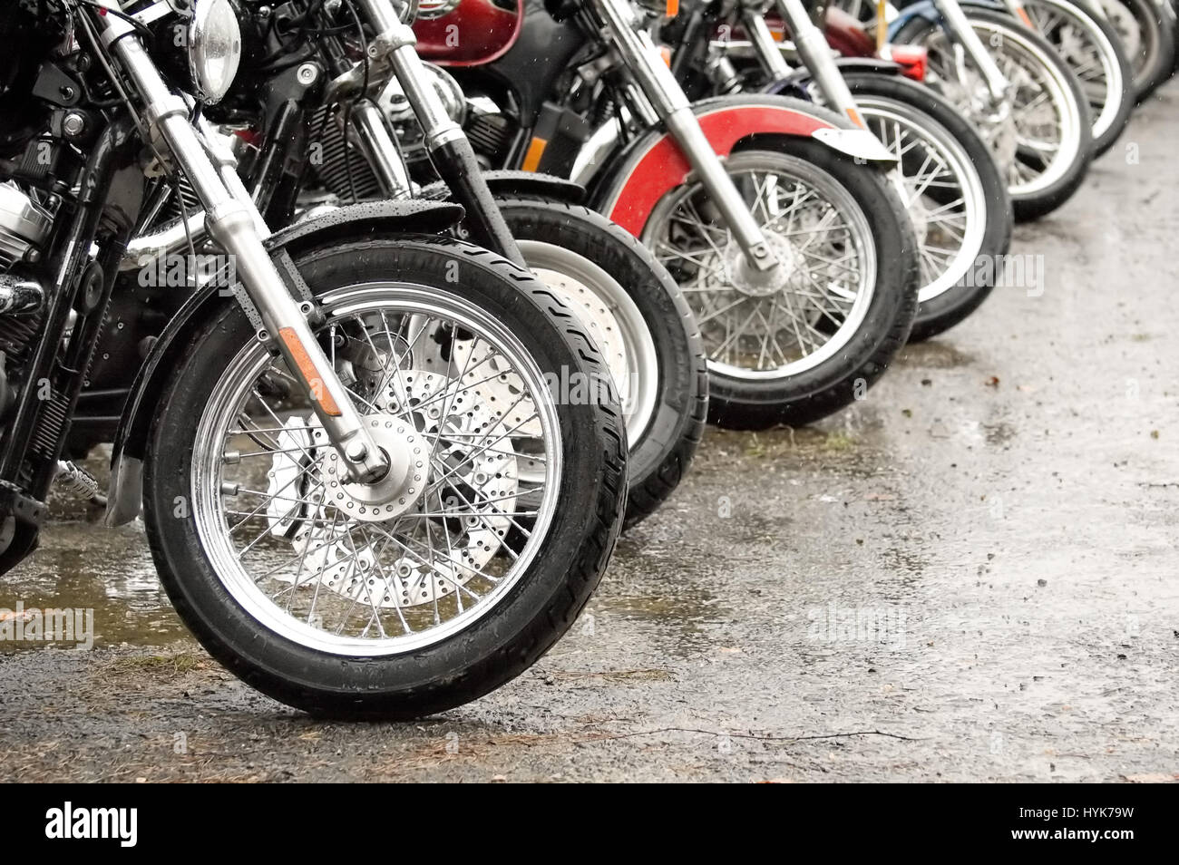 row of motorcycles parked together on a rainy day Stock Photo - Alamy